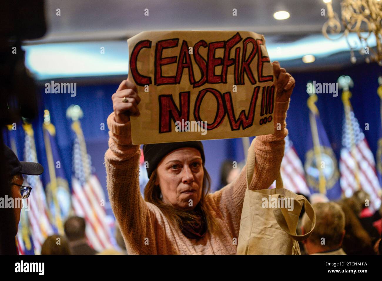 A protester holds a sign while Republican presidential hopeful Nikki ...