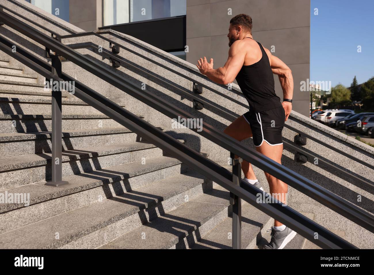 Man running up stairs outdoors on sunny day Stock Photo - Alamy