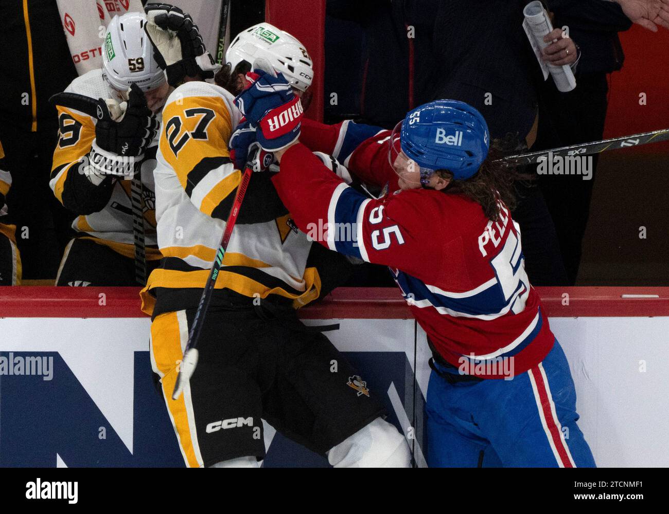 Montreal Canadiens' Michael Pezzetta (55) checks Pittsburgh Penguins' Ryan Graves (27) into the ...