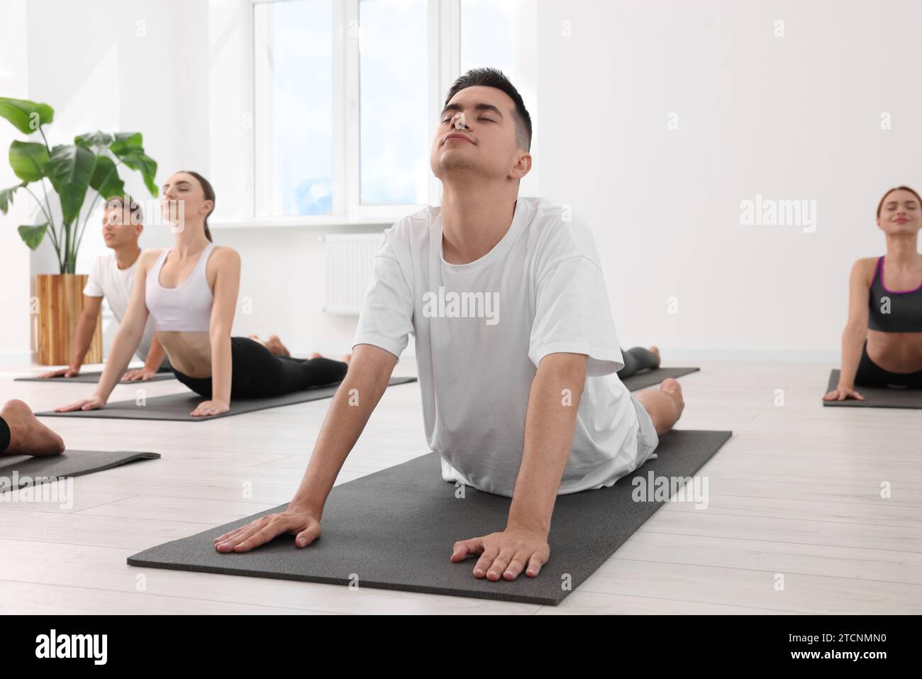 Young man practicing yoga lesson hi-res stock photography and images ...