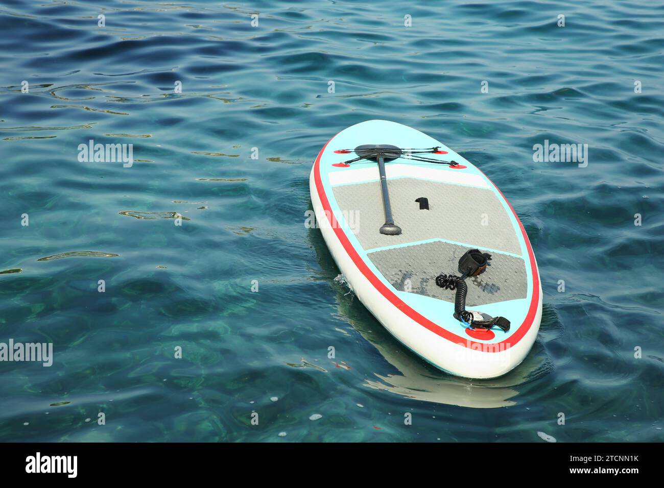 One SUP board with paddle on sea water Stock Photo - Alamy