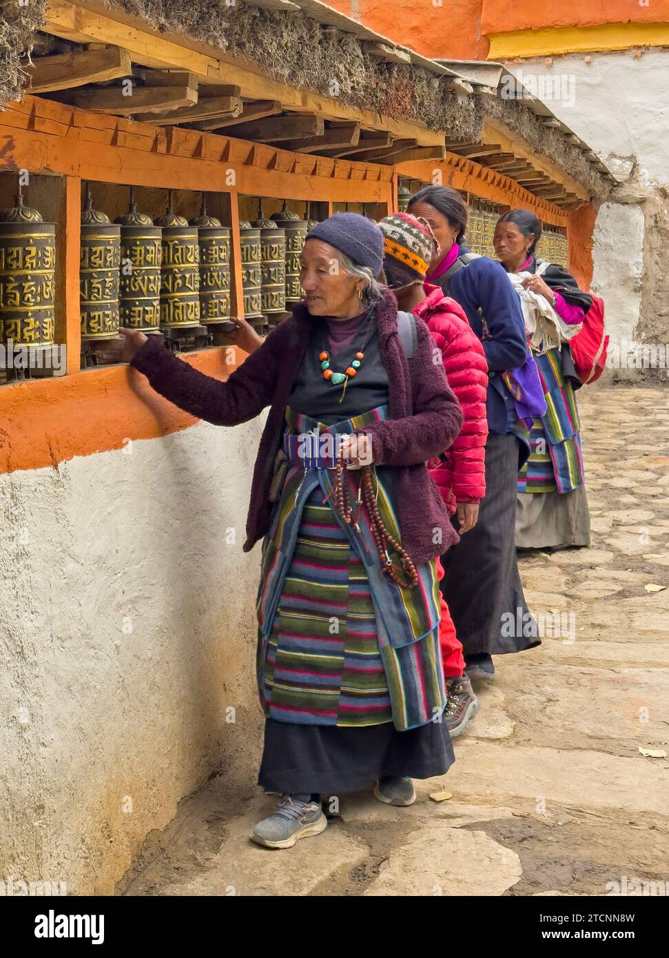 Pilgrims spin prayer wheels at Lo Gekar Monastery in Ghar village, the ...