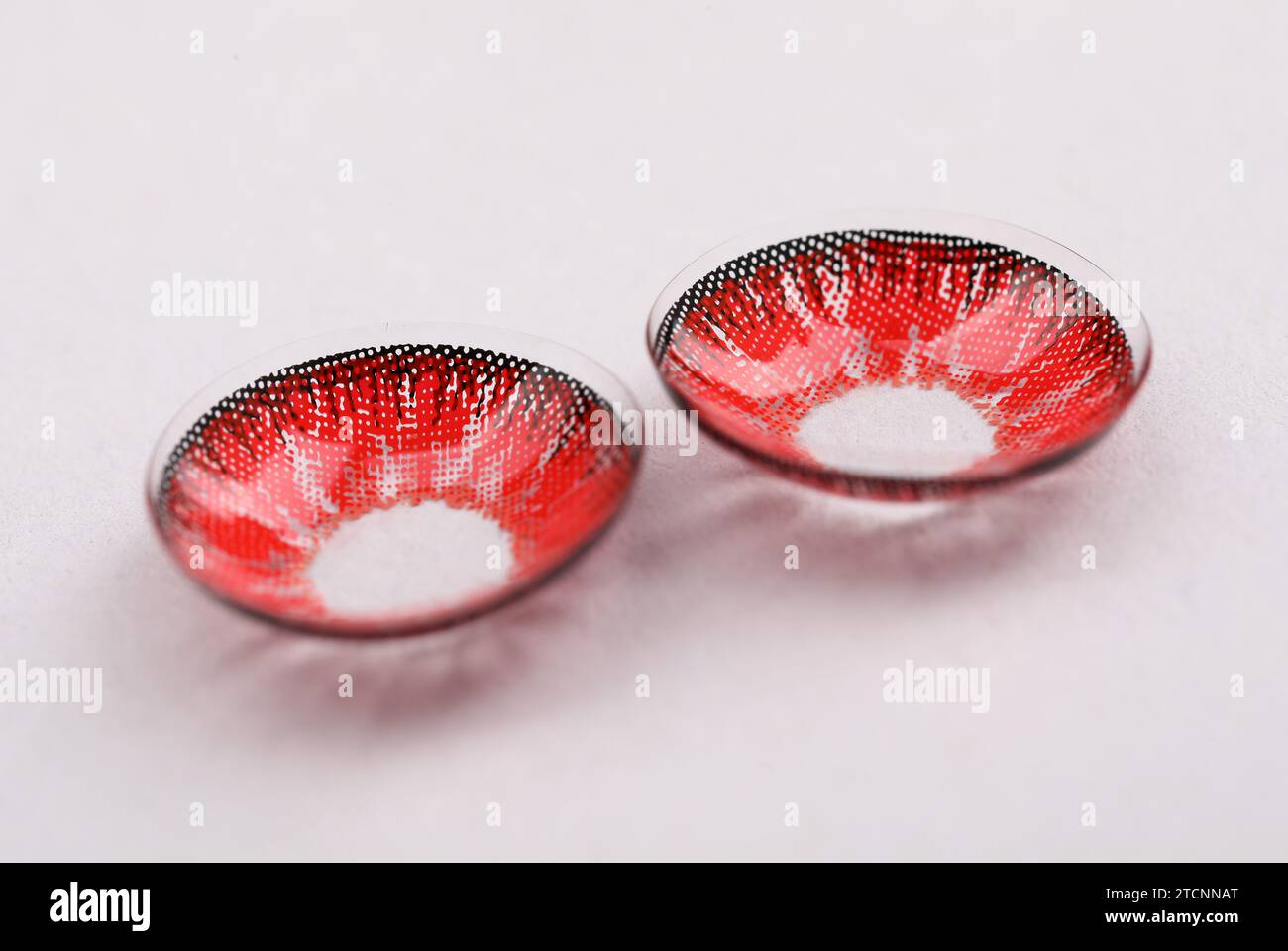 Two red contact lenses on white background Stock Photo - Alamy