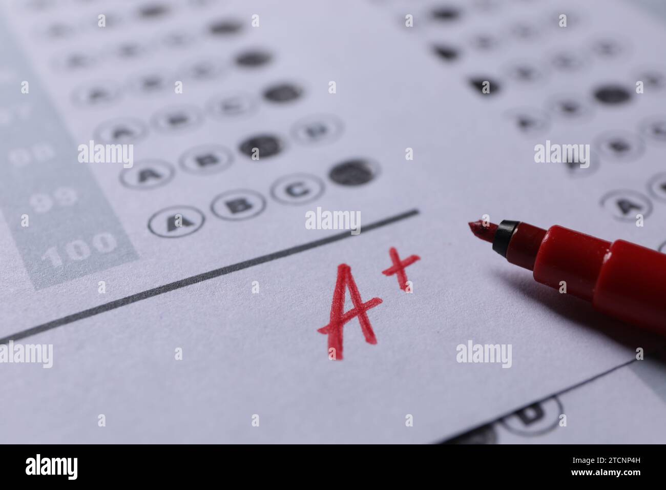 School grade. Letter A with plus symbol on answer sheet and red marker ...