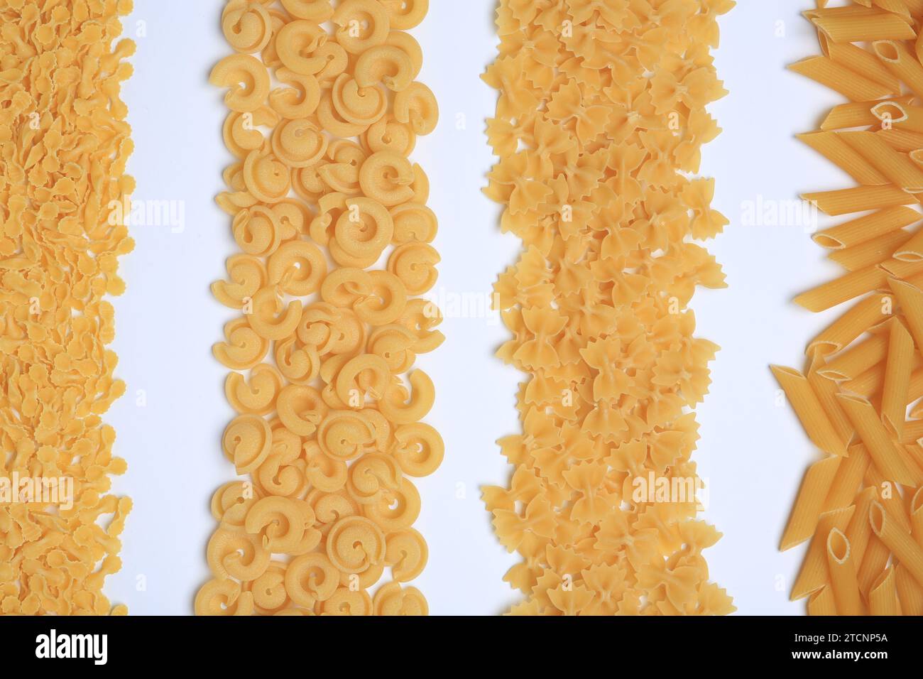 Different types of raw pasta on white background, flat lay Stock Photo ...