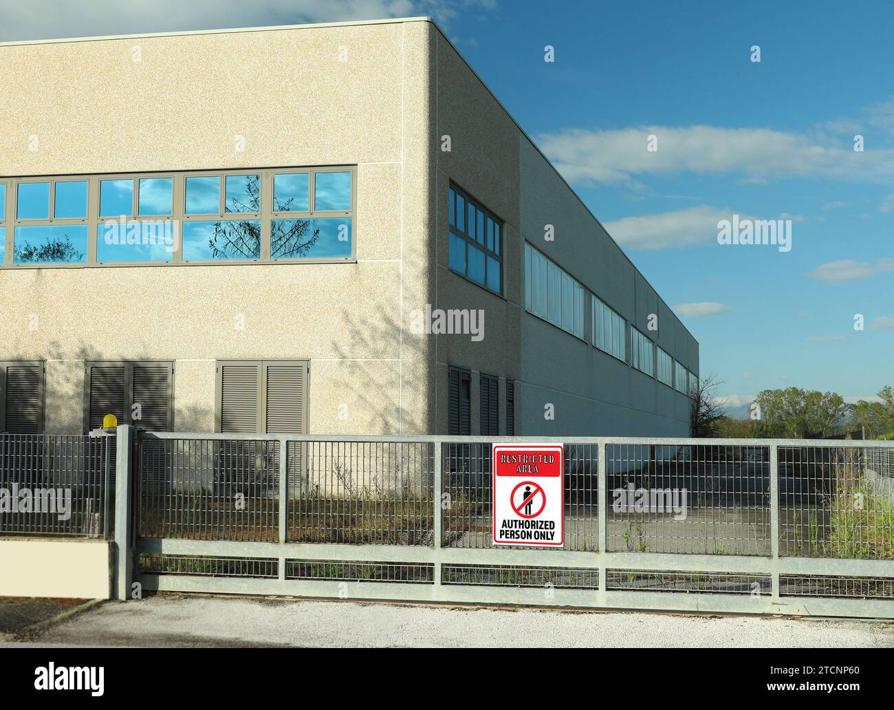 Sign with text Restricted Area Authorized Person Only on fence near ...
