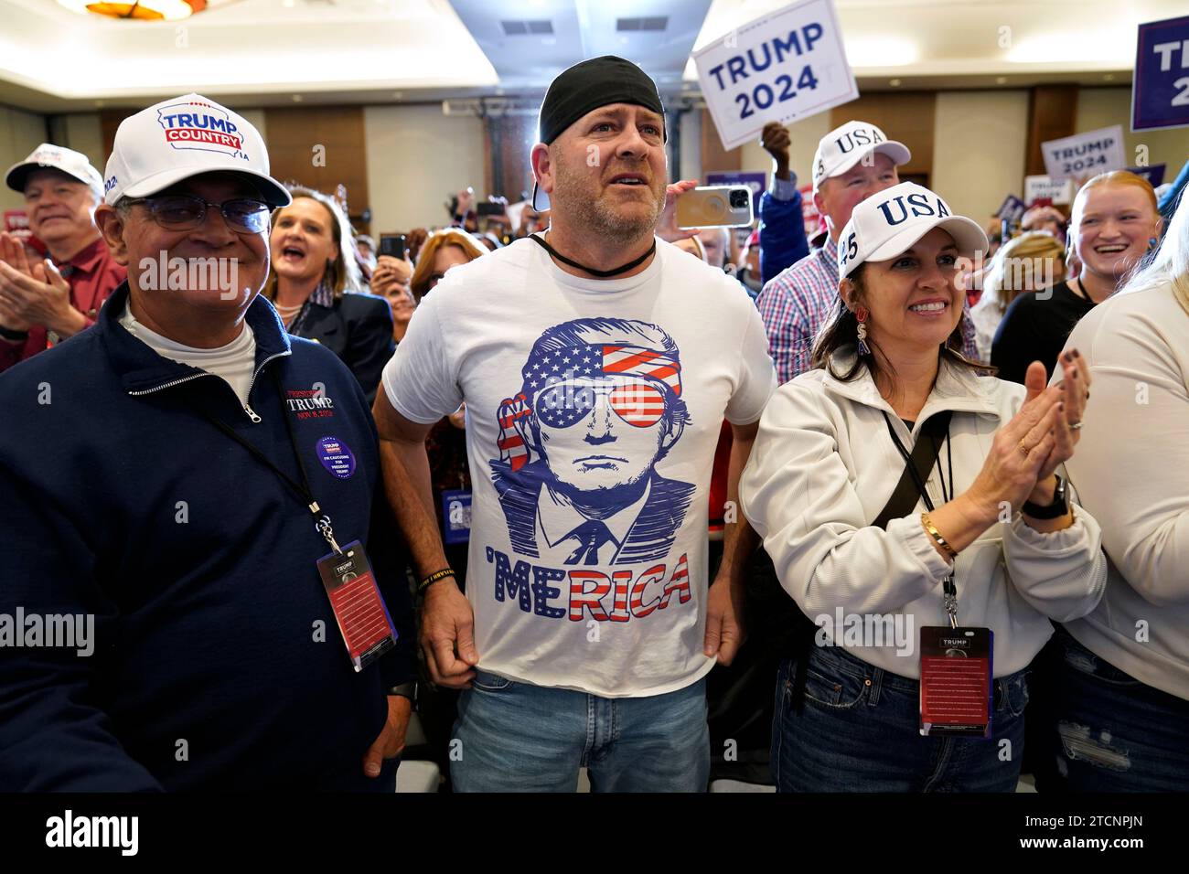 Audience members listen to former President Donald Trump speak during a ...
