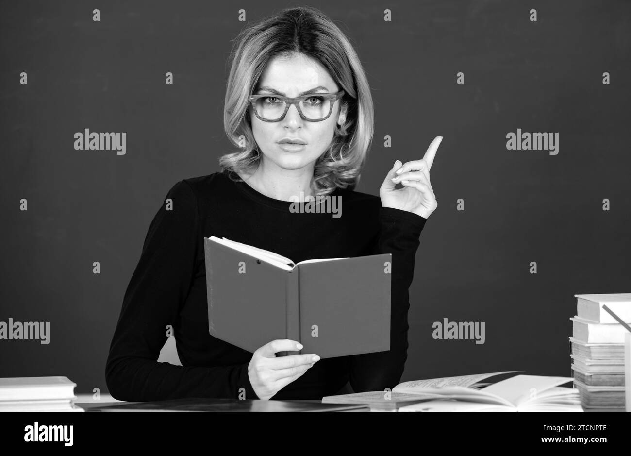 Portrait of female teacher teaching line of high school students with ...