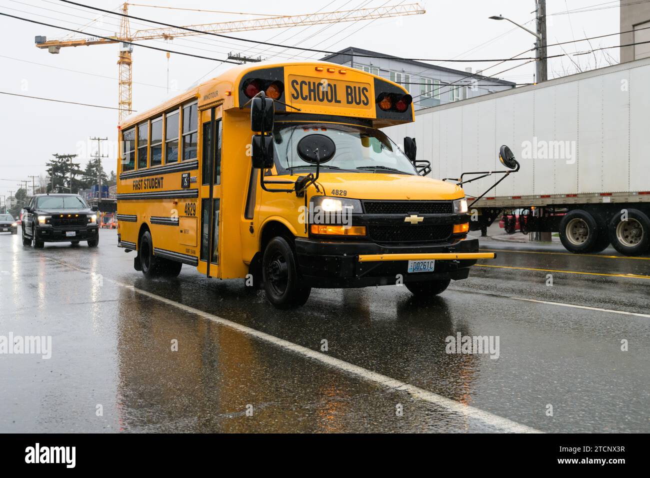 Seattle - January 12, 2023; First Student small school bus on wet ...
