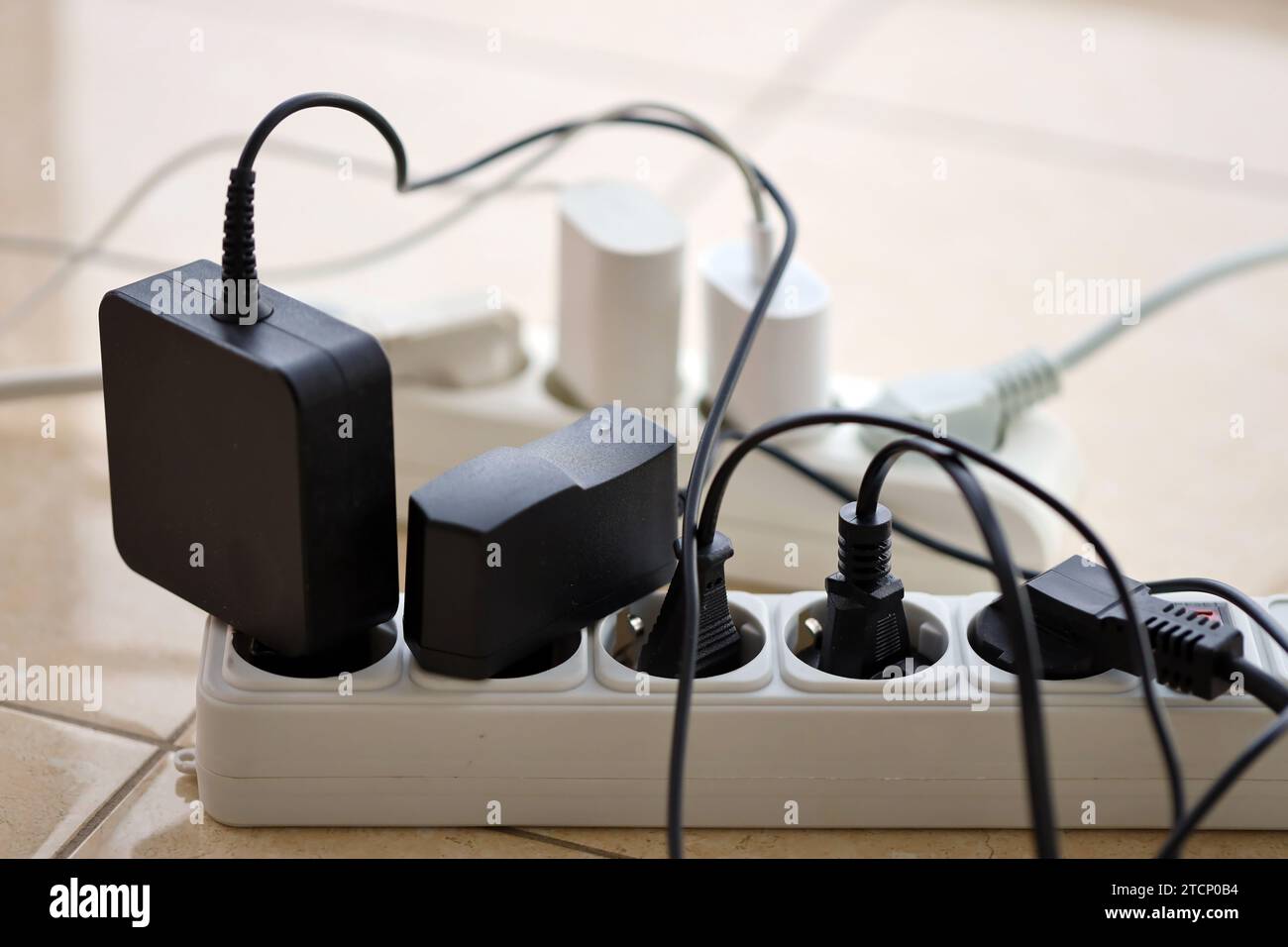 Overloaded power boards. Power strips with different electrical plugs ...