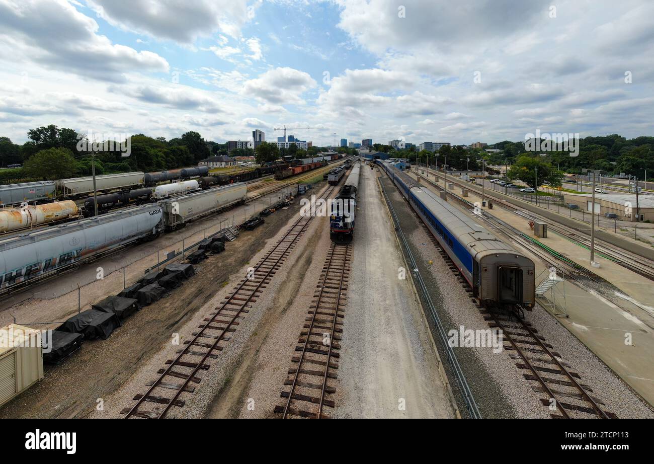 drone photos of various rail cars and amtrak trains on a cloudy day in downtown raleigh north ...