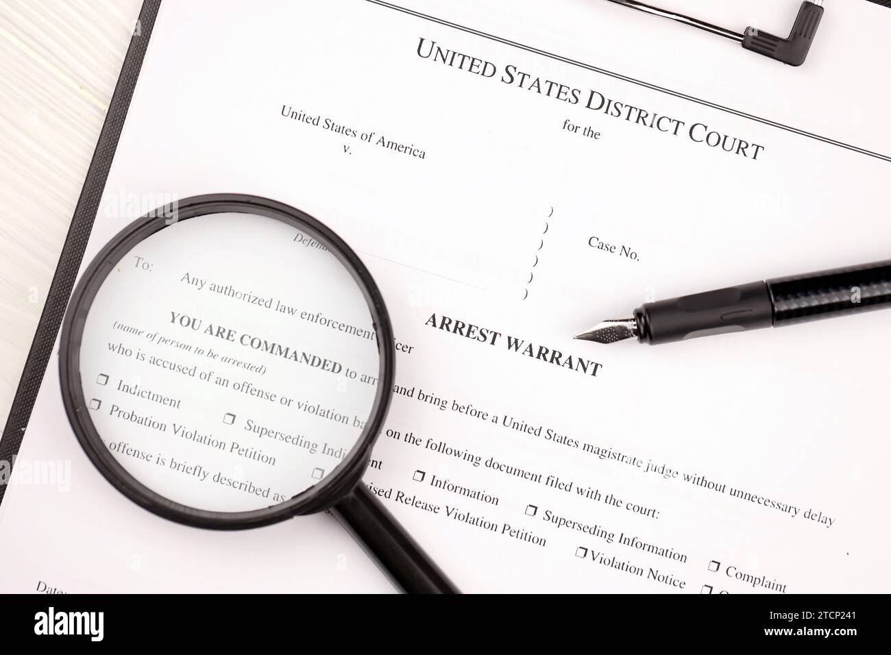 District Court Arrest Warrant court papers on A4 tablet lies on office ...