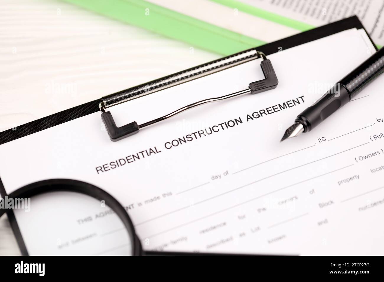 Construction contract form on A4 tablet lies on office table with pen ...