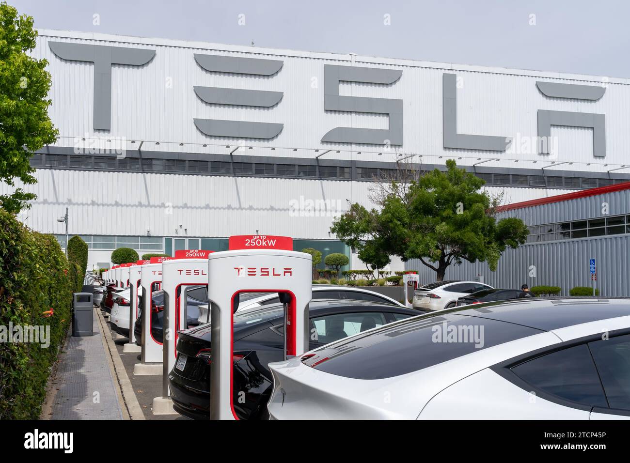 Tesla sign on the building with Superchargers at Tesla Motors Center in ...