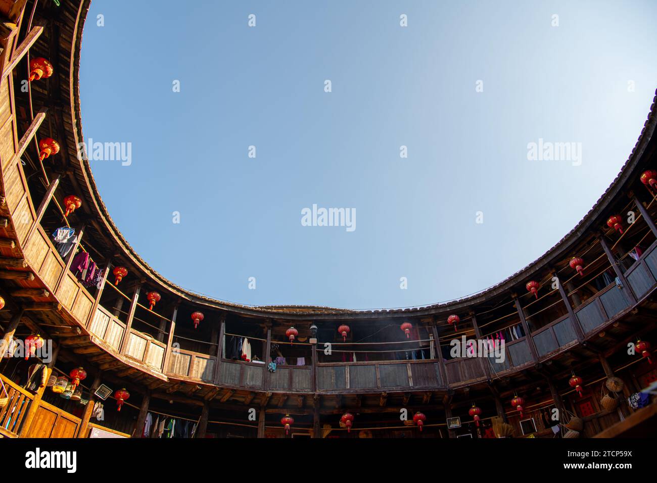 The sky above the round buildings of Hekeng Tulou Cluster in the early ...