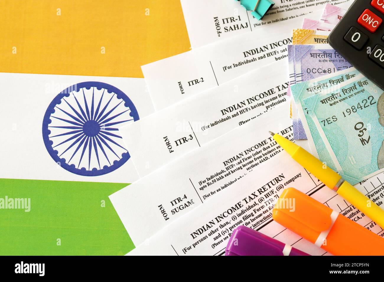 Indian income tax return blank form with pen and indian rupees bills on ...