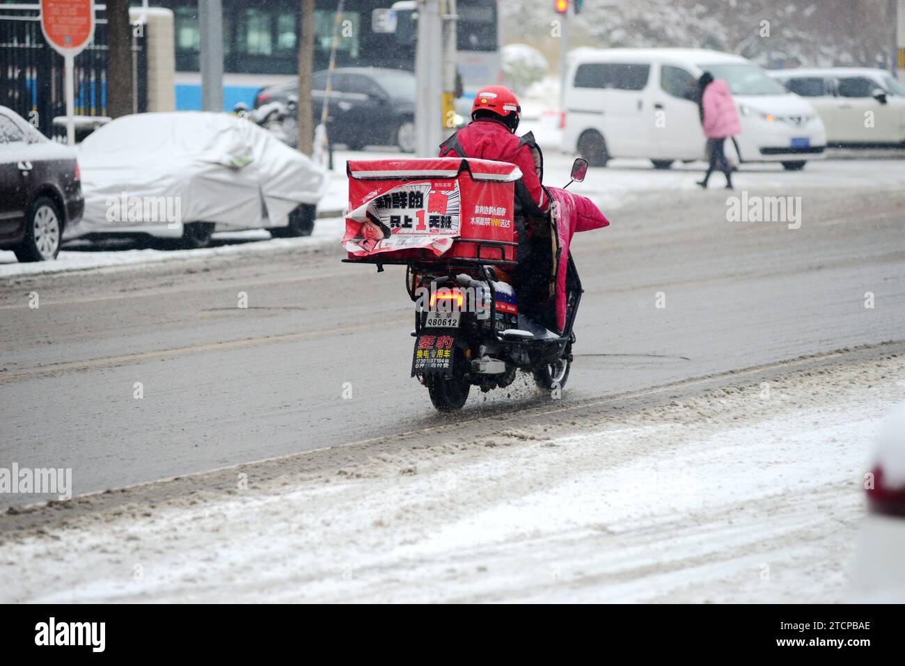 BEIJING, CHINA - DECEMBER 14, 2023 - A Courier rides during heavy snow ...