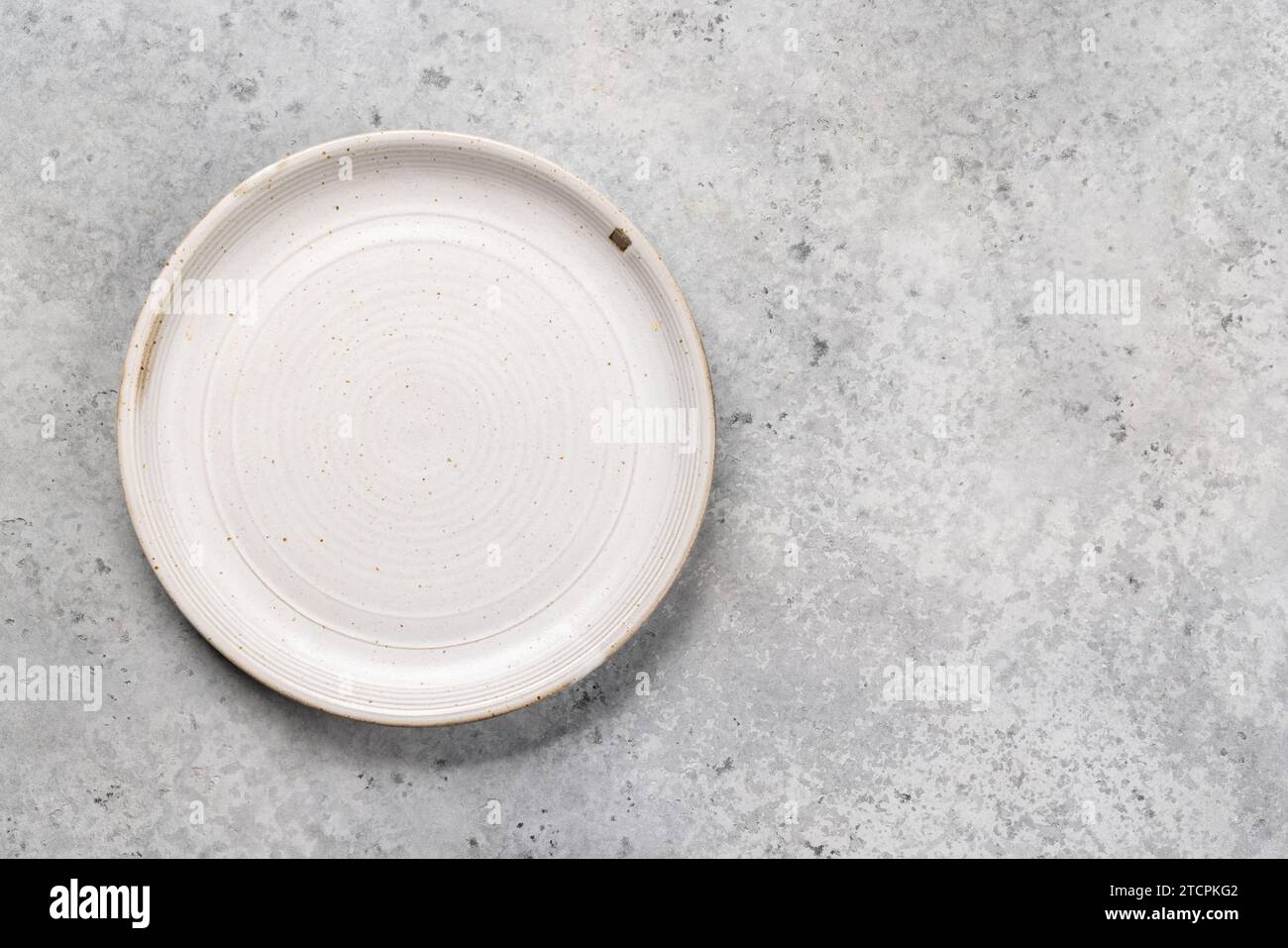 Mockup for a delicious meal. Empty plate on a table. Flat lay with copy ...