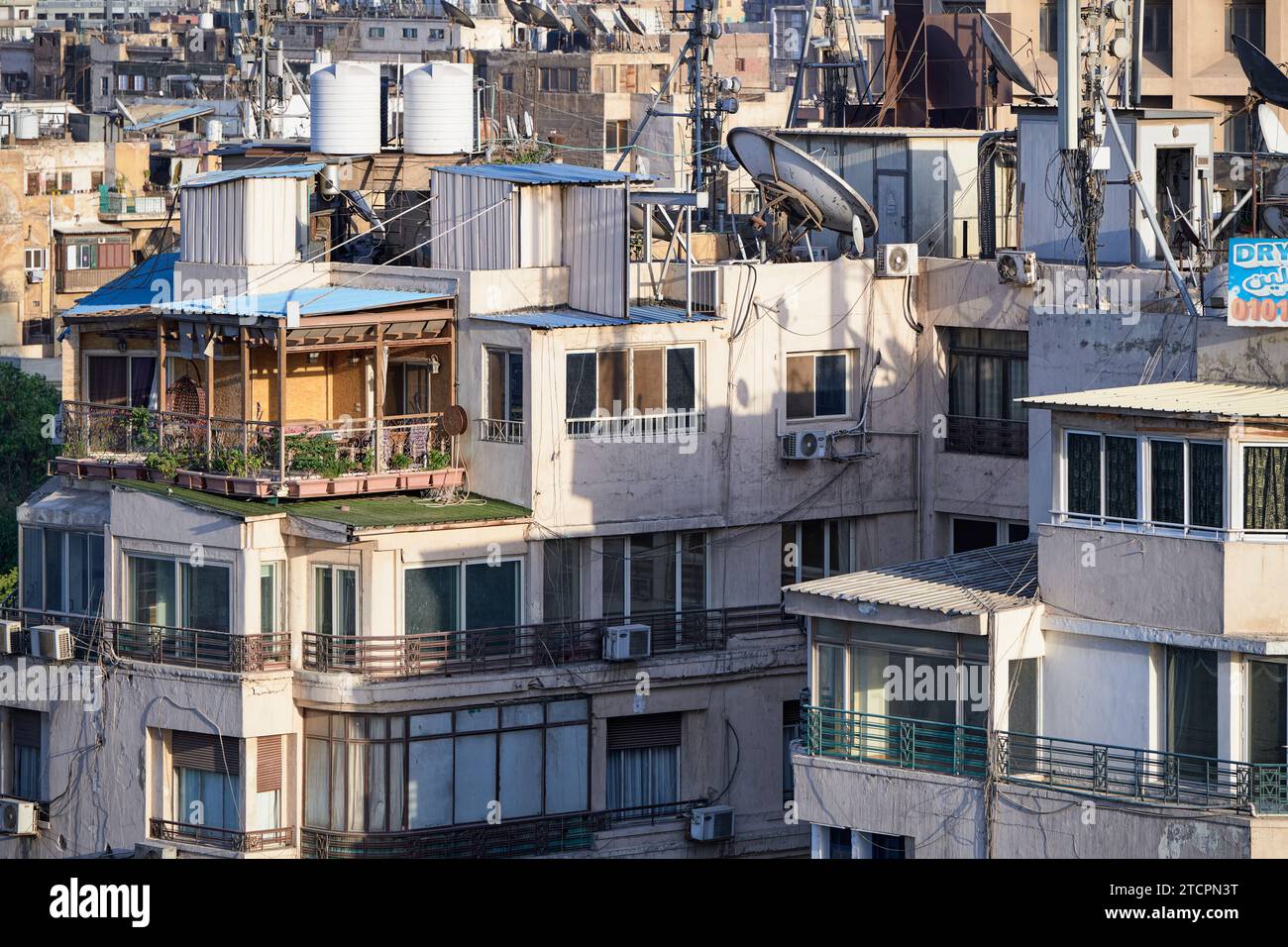 An aerial view of rooftops of old houses with television satellite ...