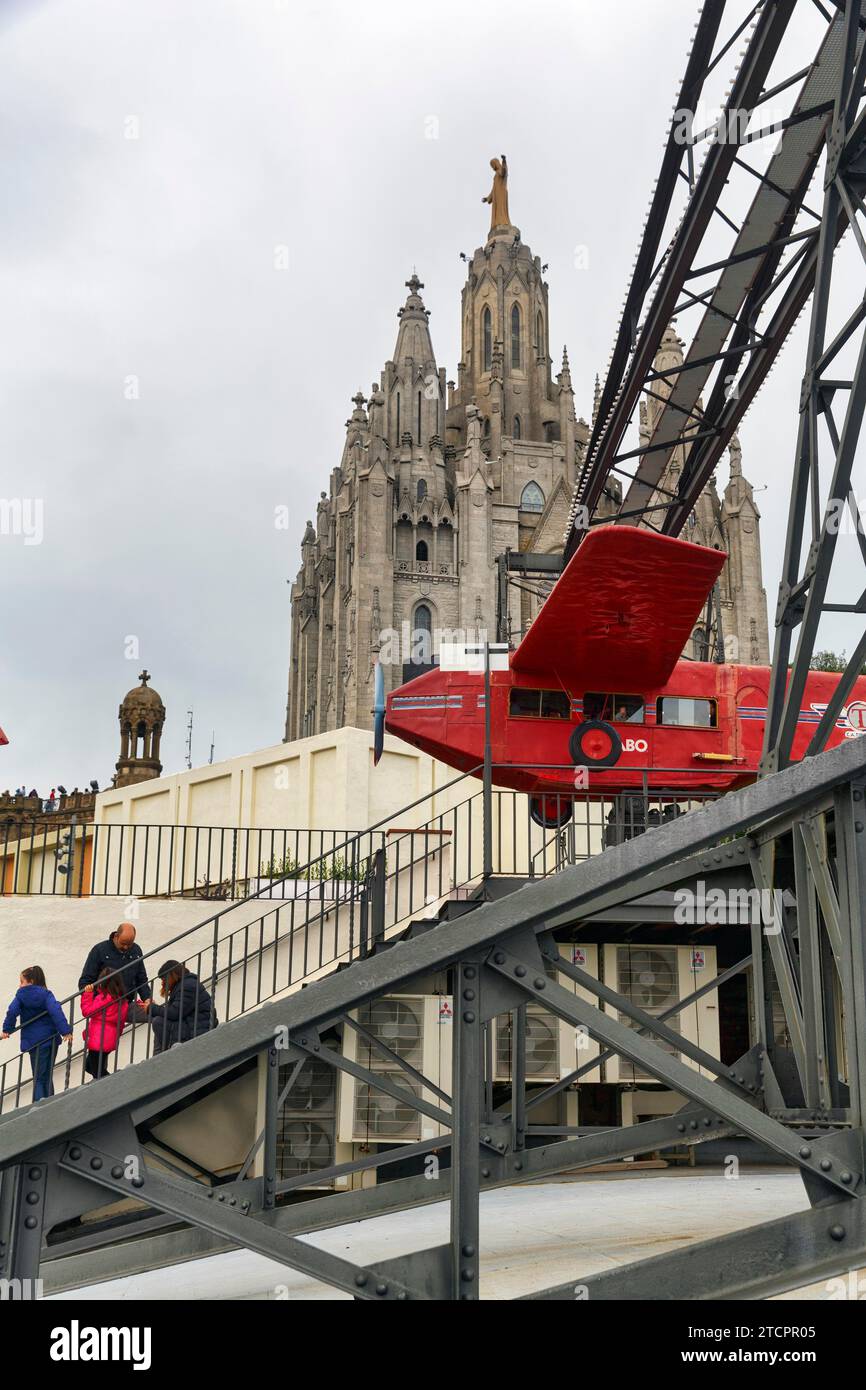 Red aeroplane, simulator, ride in front of church, Sagrat Cor, cloudy ...