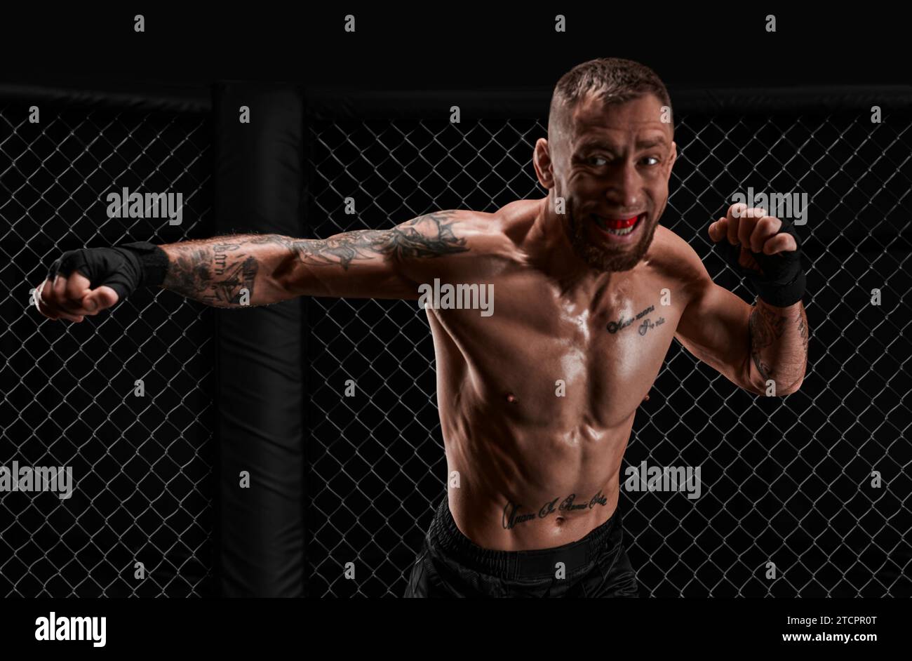 Conceptual image of a kickboxer. A real fighter stands in the real cage ...