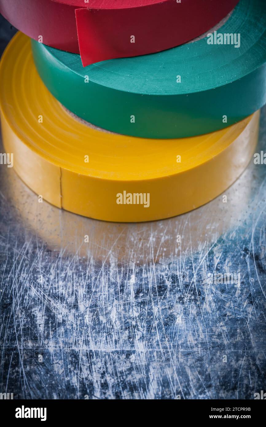 Rolls of insulating tape on scratched metallic background Electricity ...