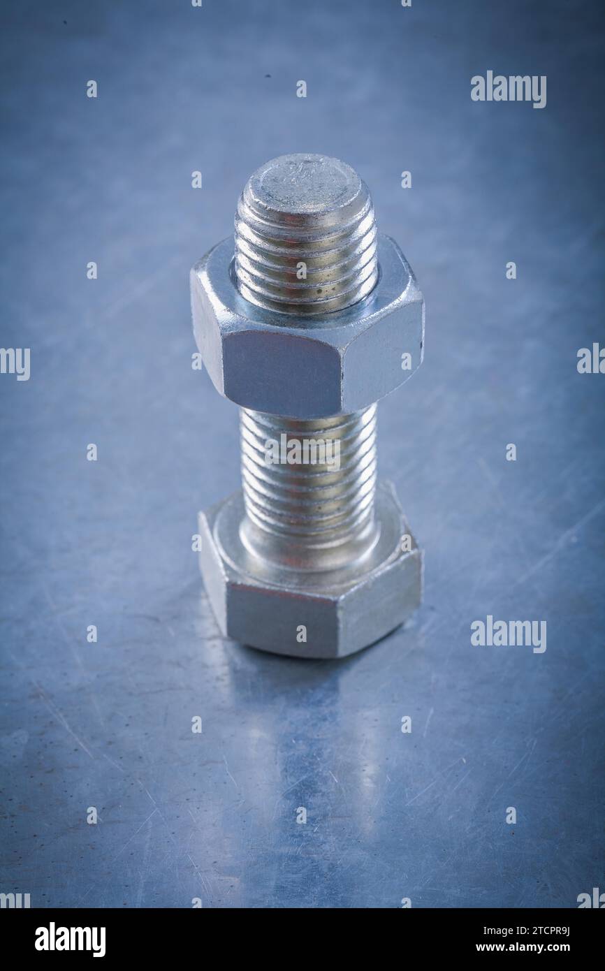 Steel threaded bolt and nut on metallic background Design concept Stock ...