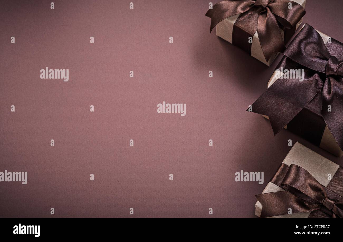 Set of wrapped gift boxes on brown surface holiday concept Stock Photo ...
