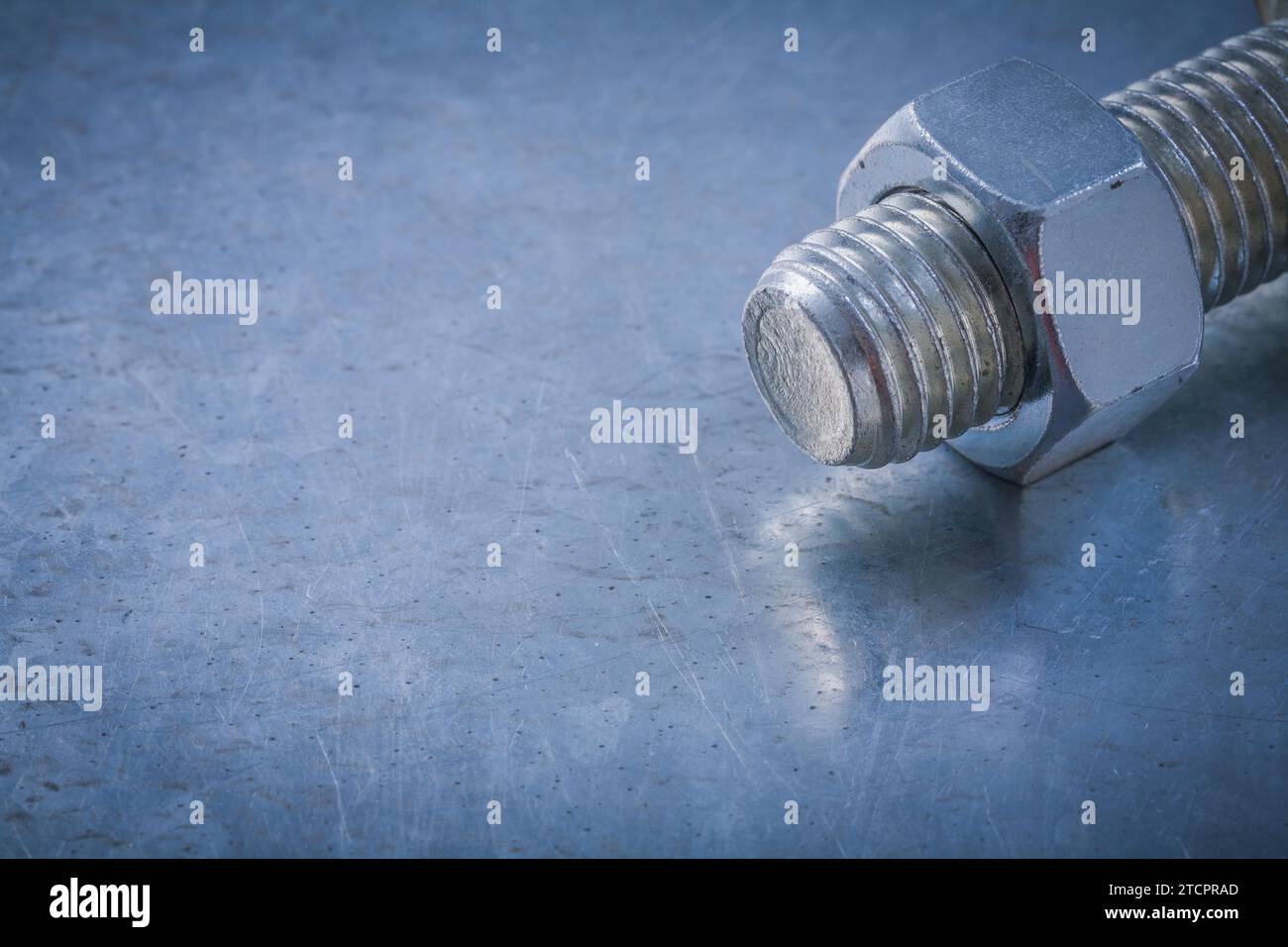 Design concept with steel threaded bolt and screw nut on a metallic ...