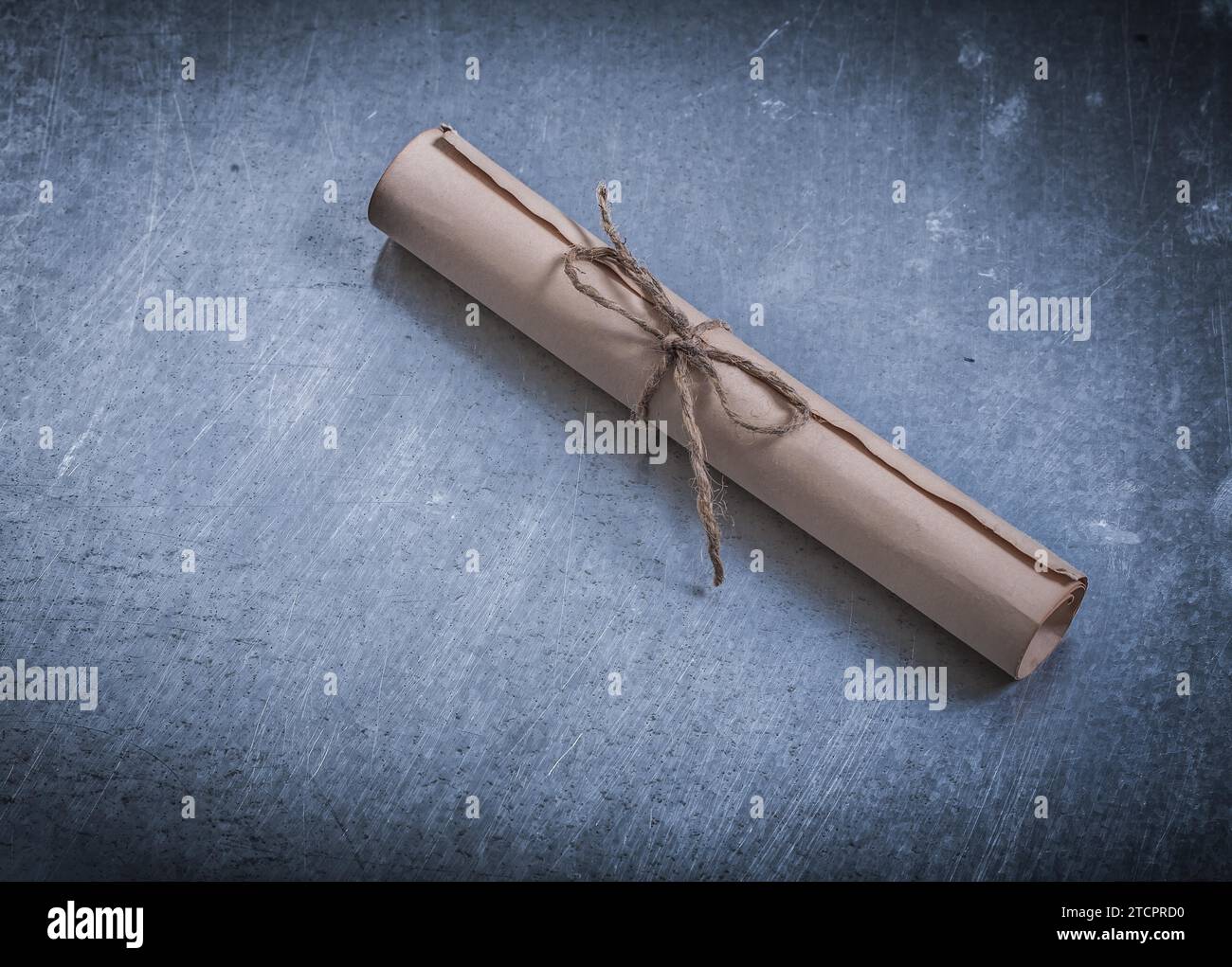 Vintage paper roll on scratched metallic background Stock Photo - Alamy