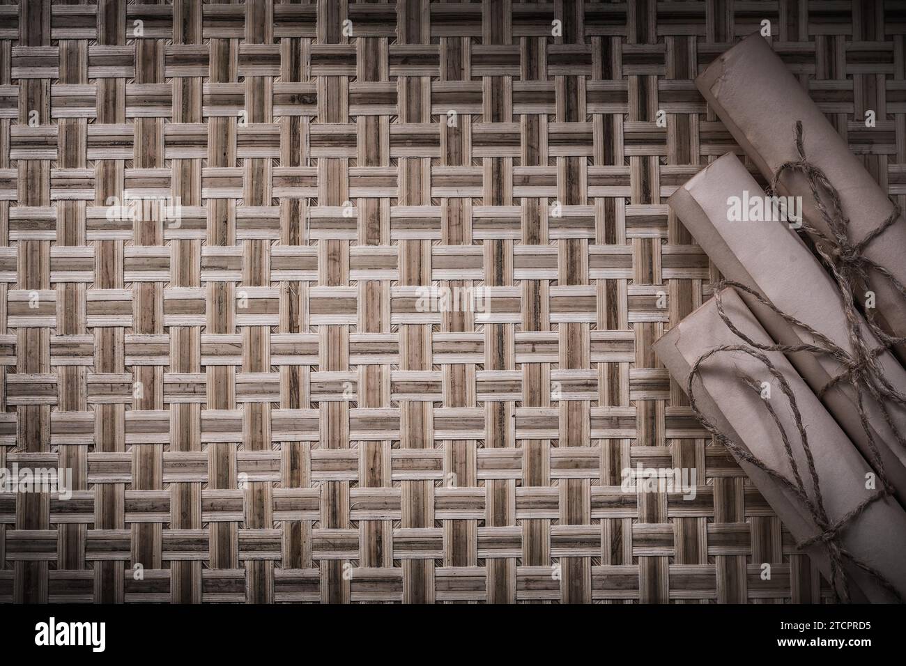 Vintage paper rolls on wicker background Stock Photo - Alamy