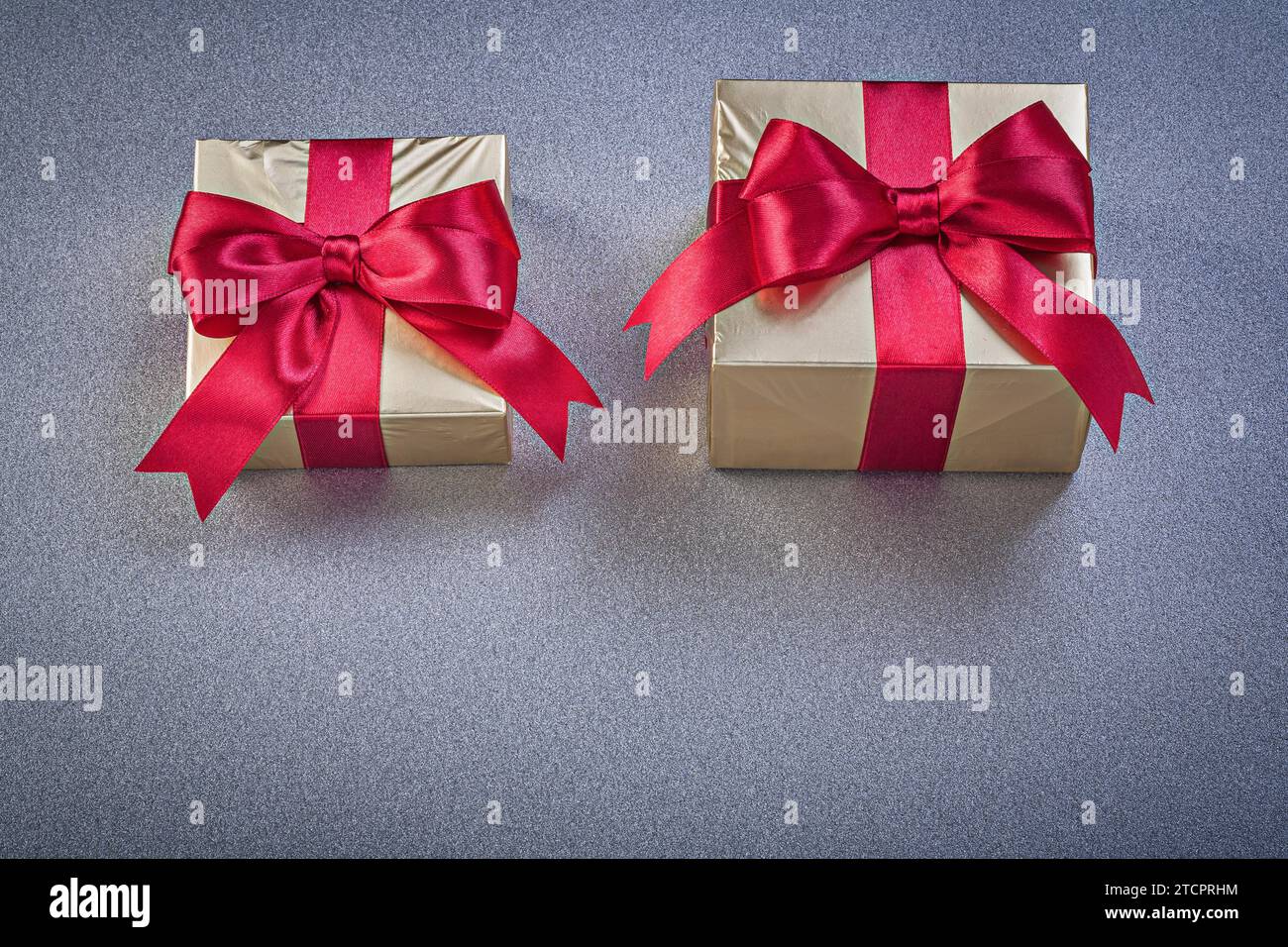 Boxed gifts with red bows on grey background holiday concept Stock ...
