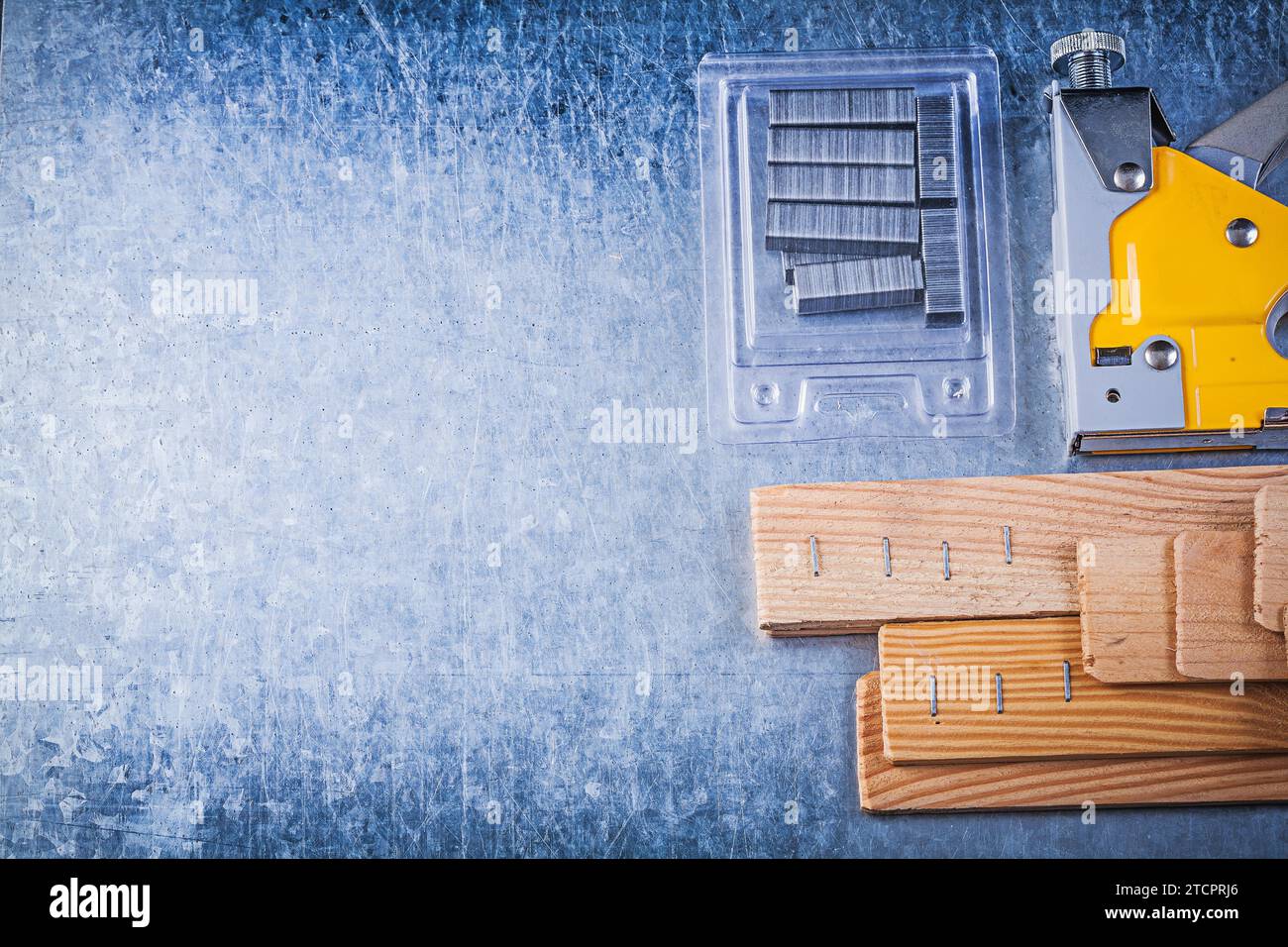 Construction stapler chrome staples wood building board on metallic ...