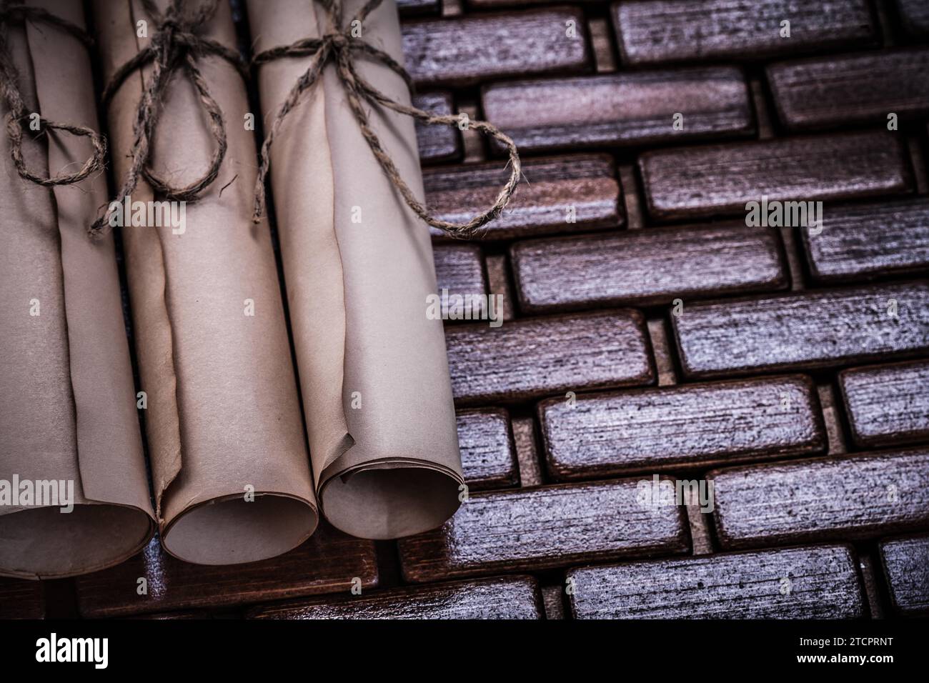 Pile of antique paper rolls on a wicker mat Stock Photo - Alamy
