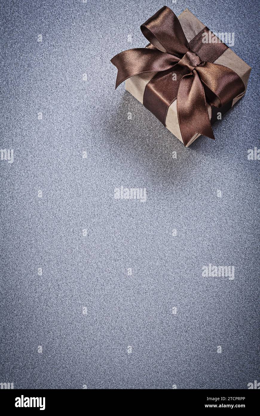 Gift box with tied brown knot on grey background Celebration concept ...