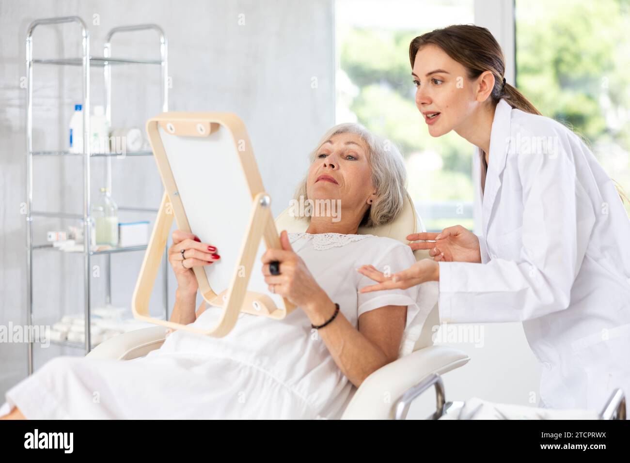 Mature patient with mirror Stock Photo - Alamy