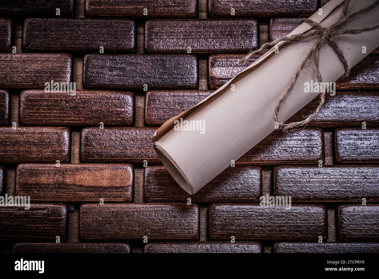 Vintage rolled paper on a wicker mat Stock Photo - Alamy