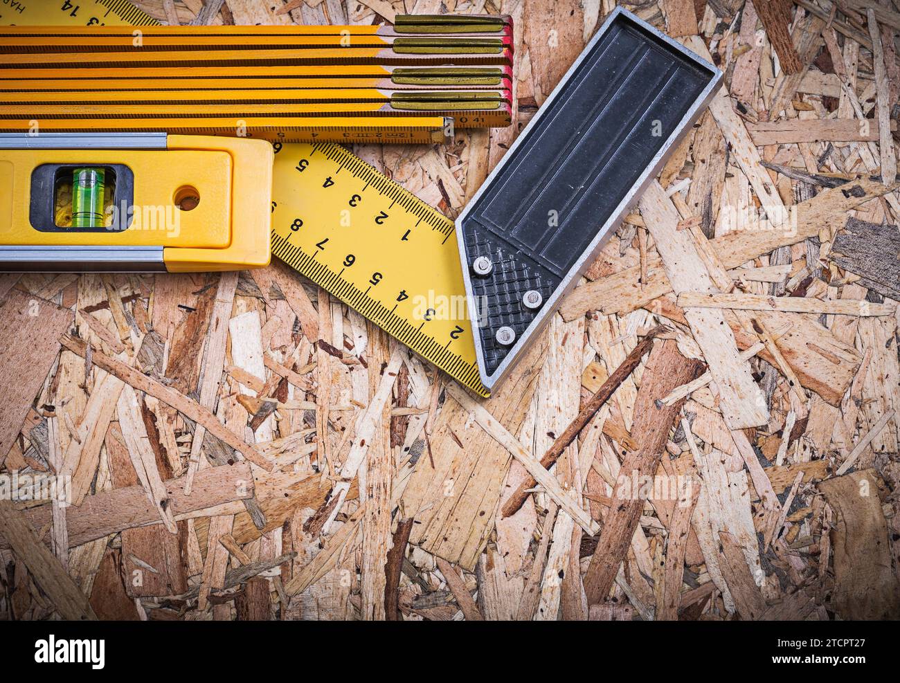 Yellow square ruler building level wood metre on chipboard Stock Photo ...