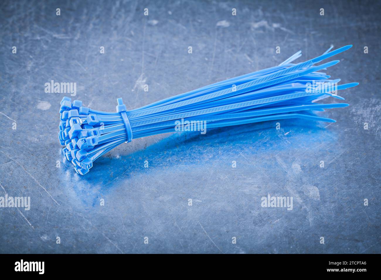 Blue self-locking plastic cable ties on a metallic background Design ...