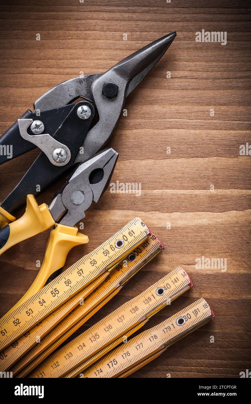 Composition of tin snips pliers wood metre construction concept Stock ...