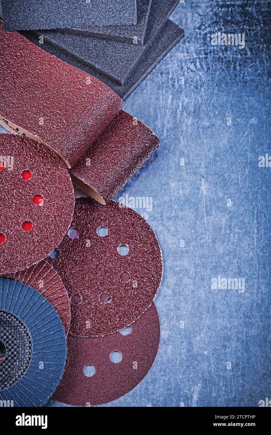 Composition of grinding tools on metallic background, view from above ...