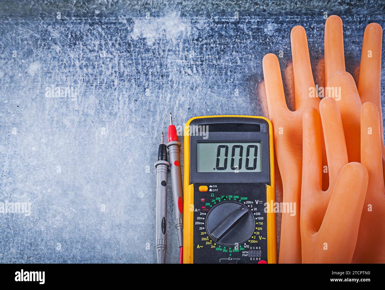 Digital multimeter dielectric rubber gloves on metallic background ...