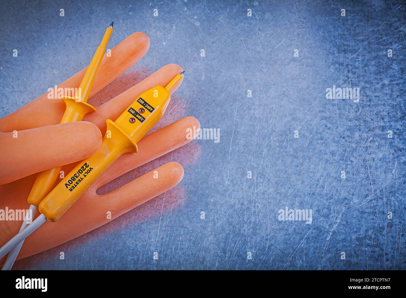 Dielectric rubber gloves Electrical test device on metallic background ...