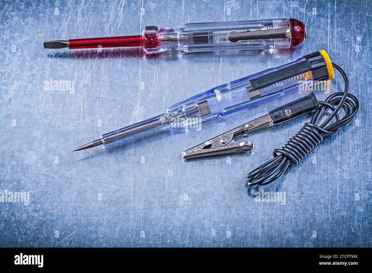 Electrical tester screwdriver crocodile plug on metallic background ...