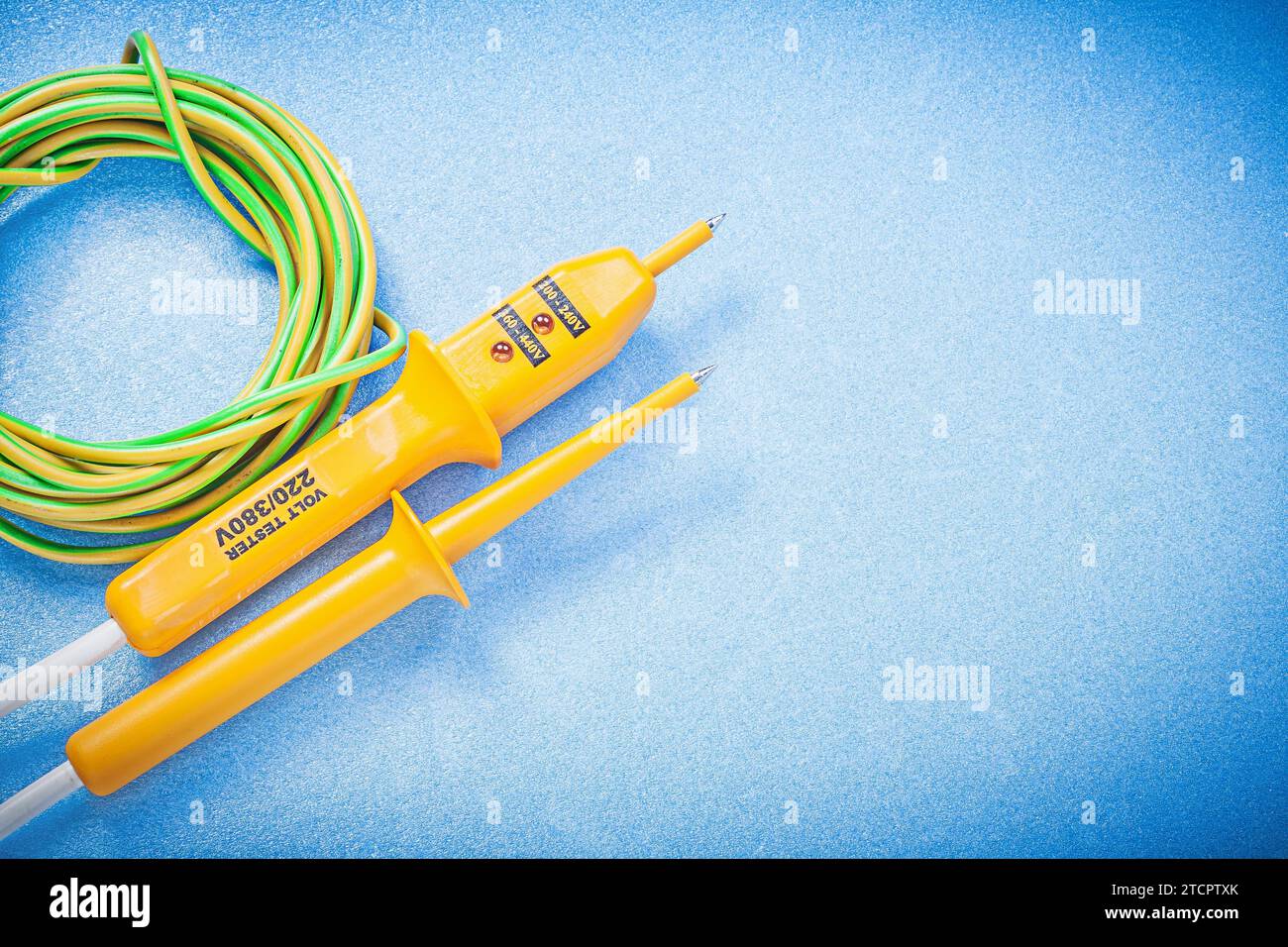 Electrical tester rolled wire on blue background Electricity concept ...