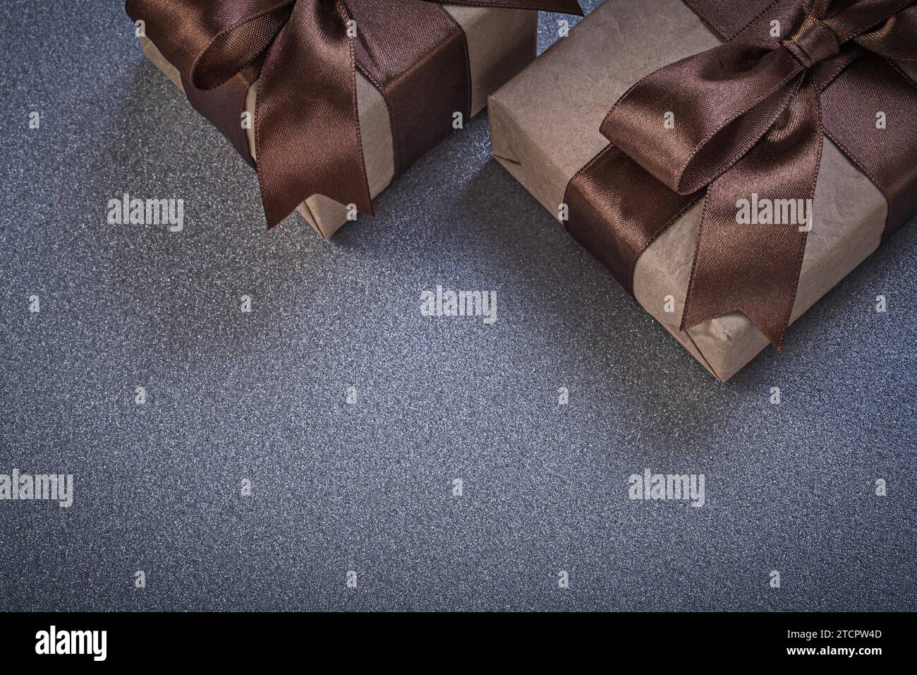 Gift boxes with brown knots on a grey background Celebration concept ...