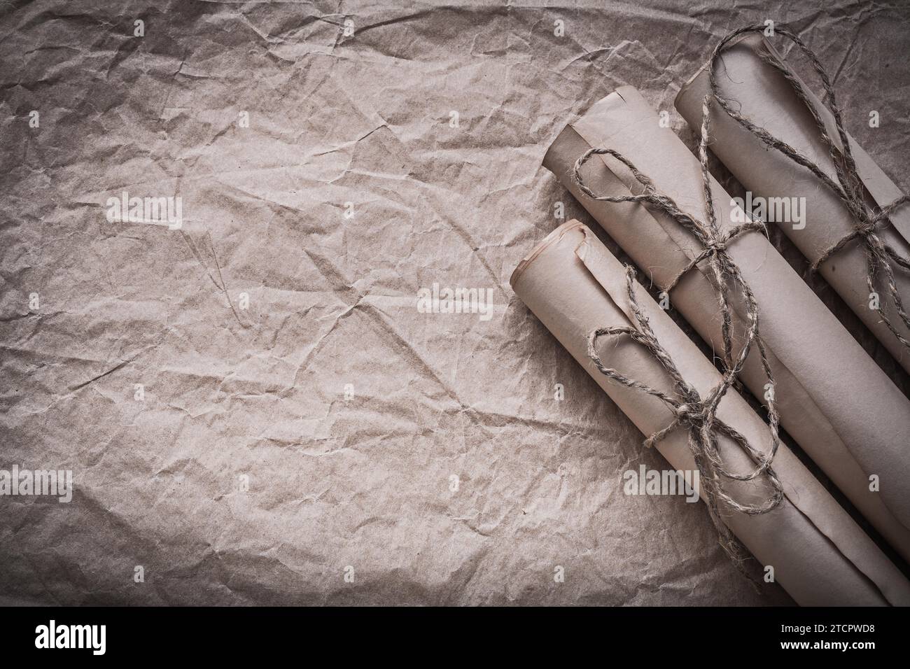 Pile of old paper rolls on crumpled packaging paper Stock Photo - Alamy