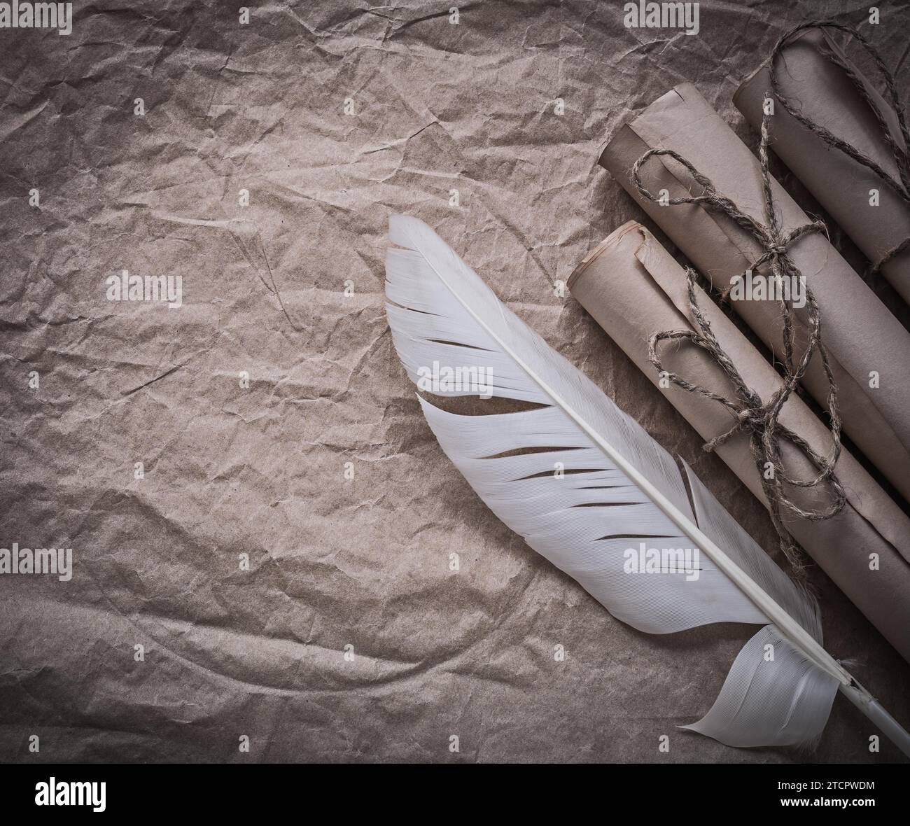 Pile of old paper rolls on crumpled packaging paper Stock Photo - Alamy