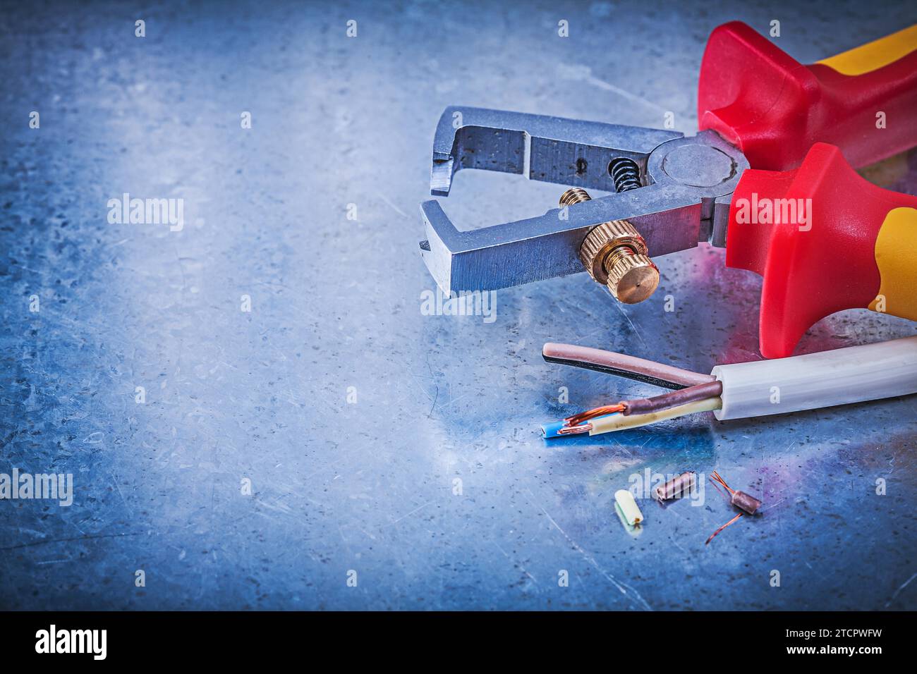 Insulated wire strippers Electrical wires on a metallic background ...