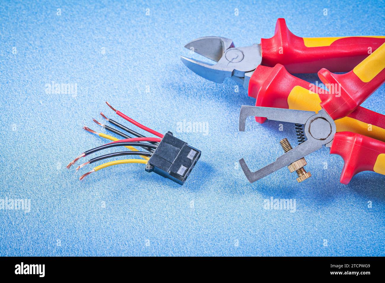 Insulation strippers set of electrical wires pliers on blue background ...